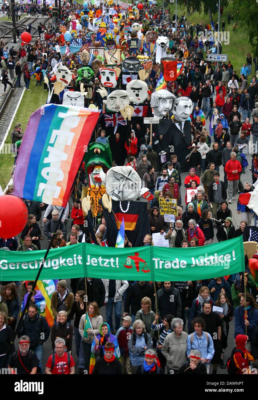 Anti-globalisation critics carry banners and and papier-maché effigies ...