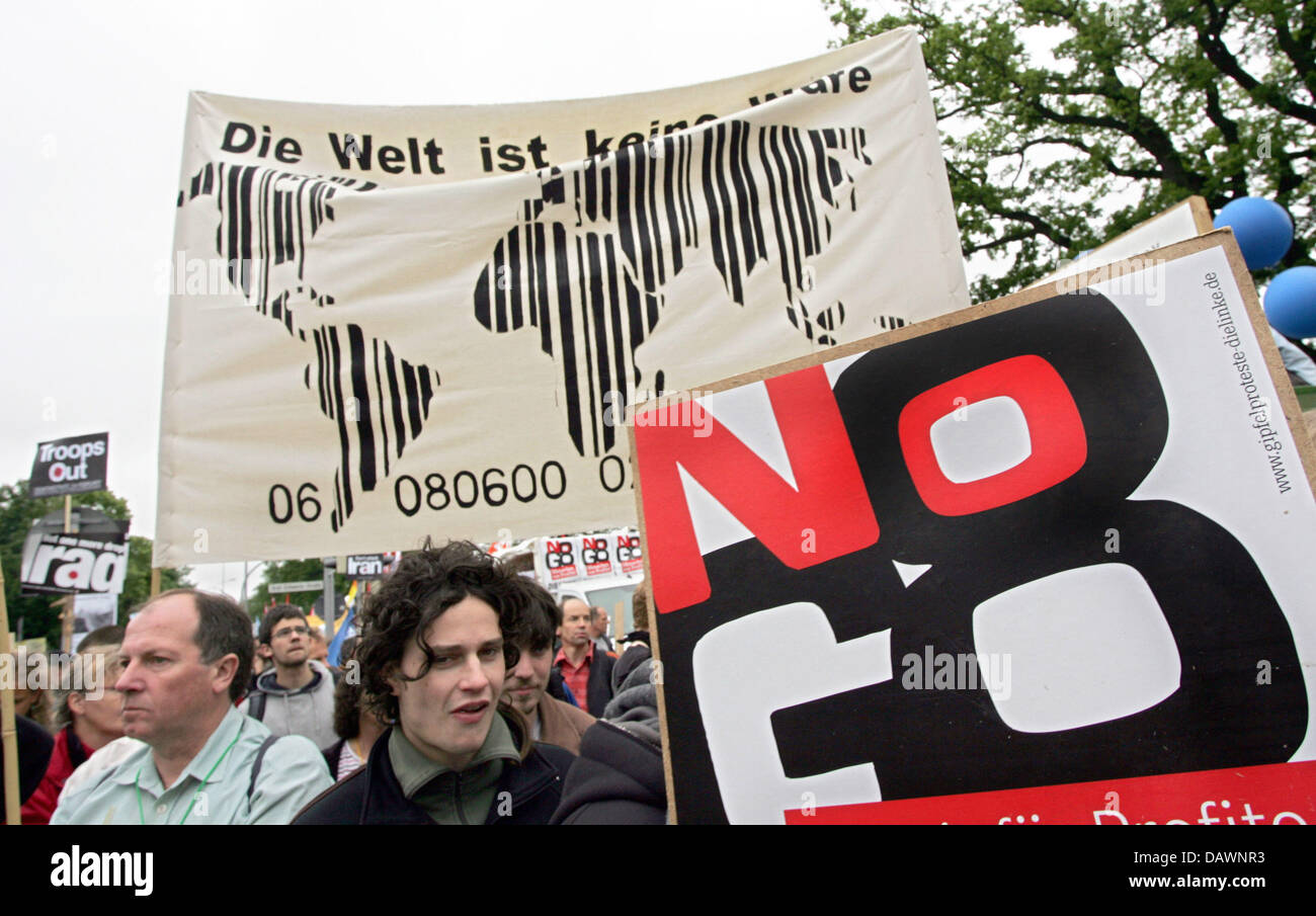 Anti-globalisation activists carry banners reading 'The world is no ...