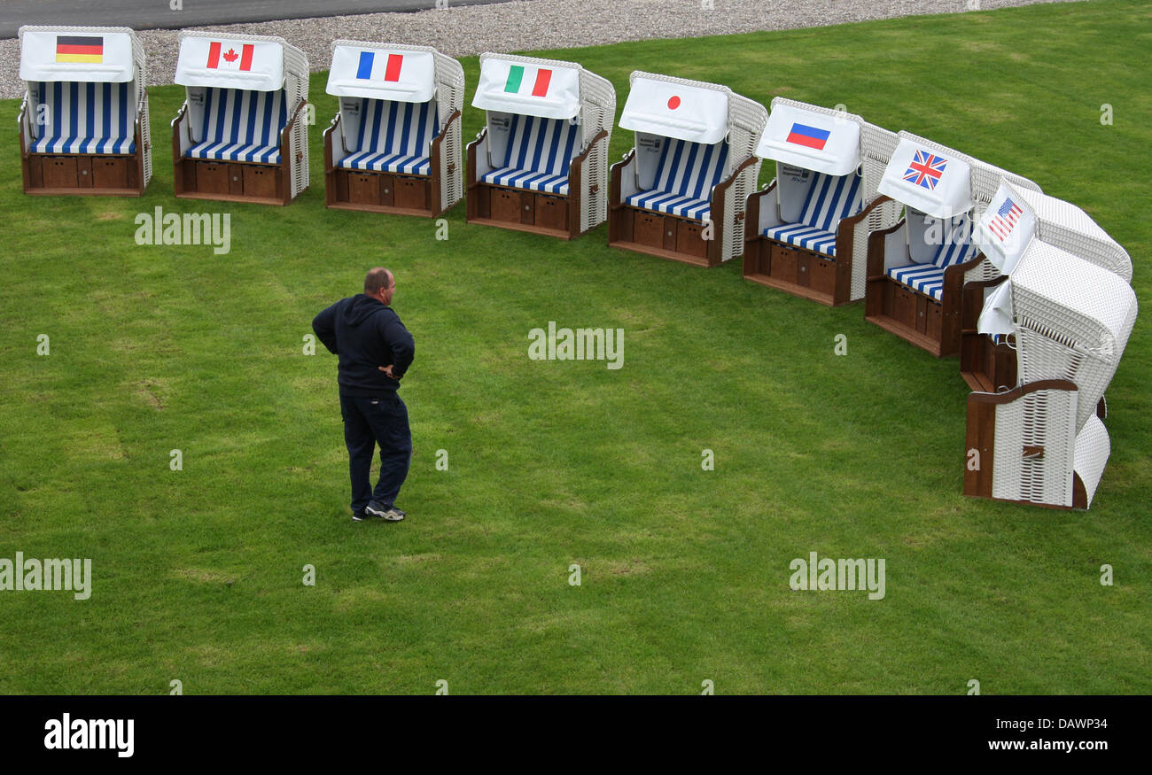 Staff of the G8 Summit press centre put up beach chairs with the flags ...