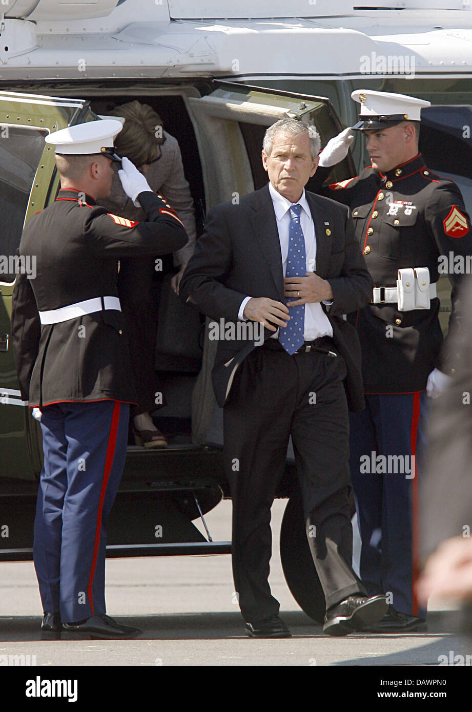 US President George W. Bush salutes exiting the helicopter as he ...