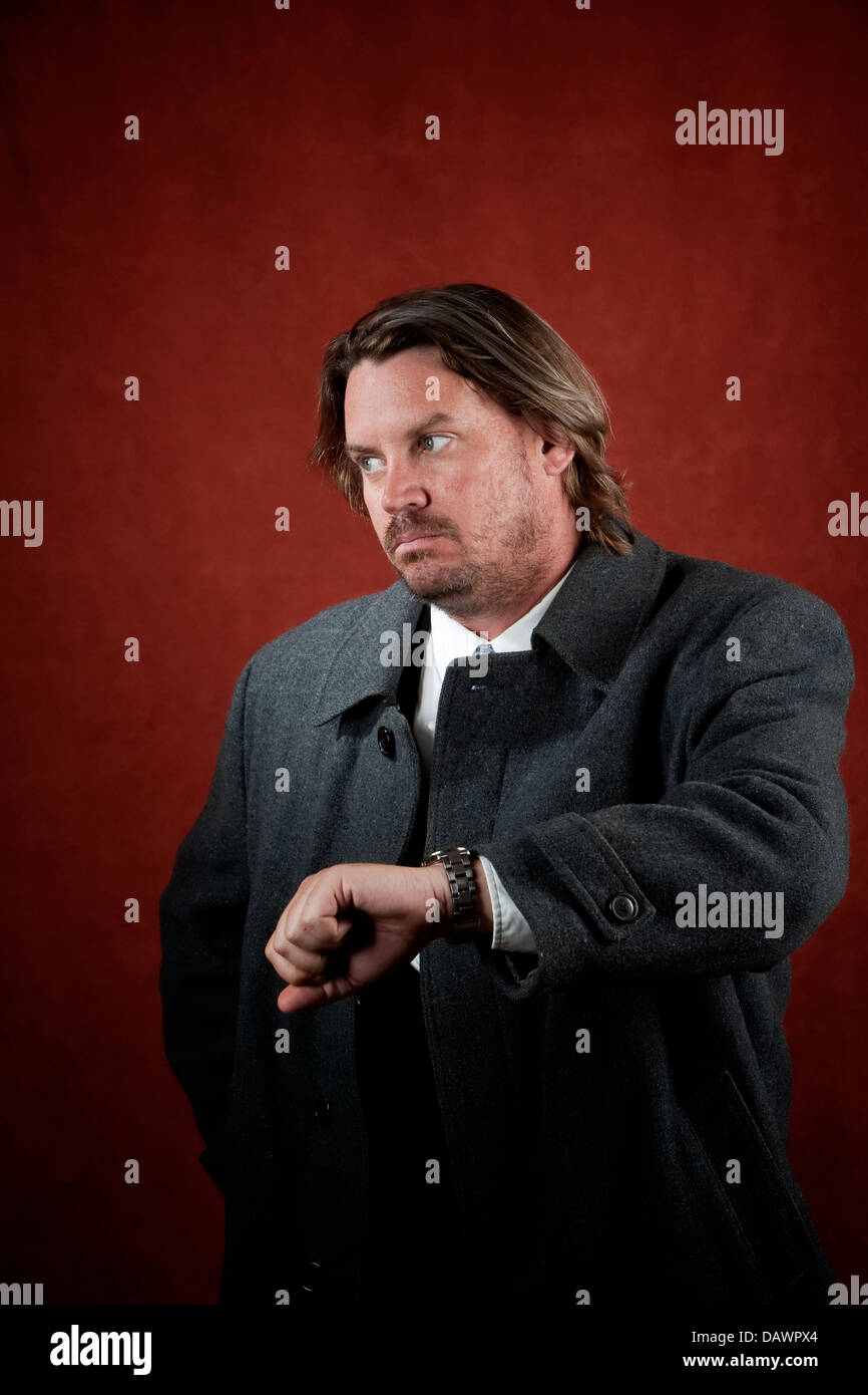 Businessman checking watch Stock Photo - Alamy