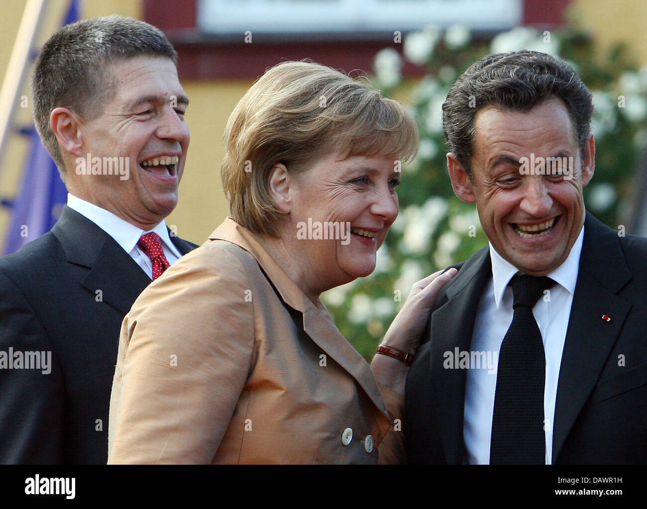 German Chancellor Angela Merkel (C) and her husband Joachim Sauer (L ...