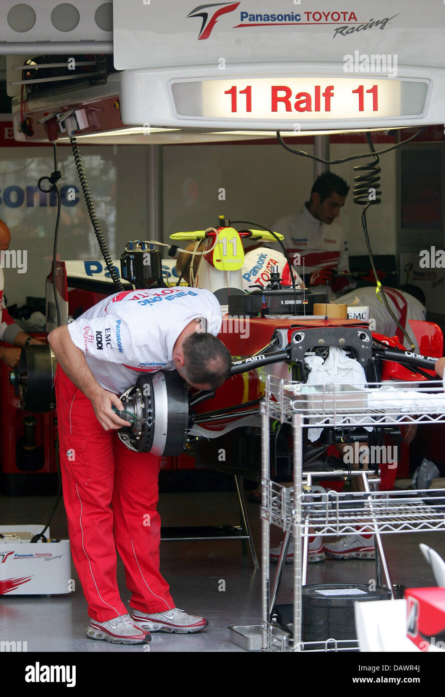 A Toyota F1 mechanic works on the race car of German Formula One driver ...