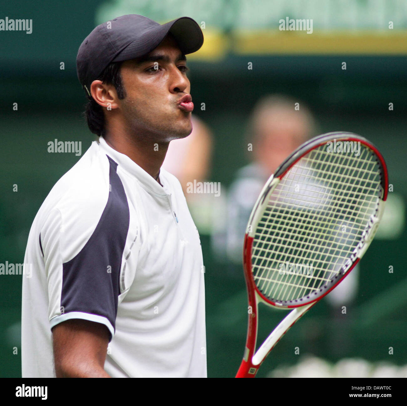 Pakistani tennis pro Aisam-Ul-Haq Qureshi makes a face in his round of ...