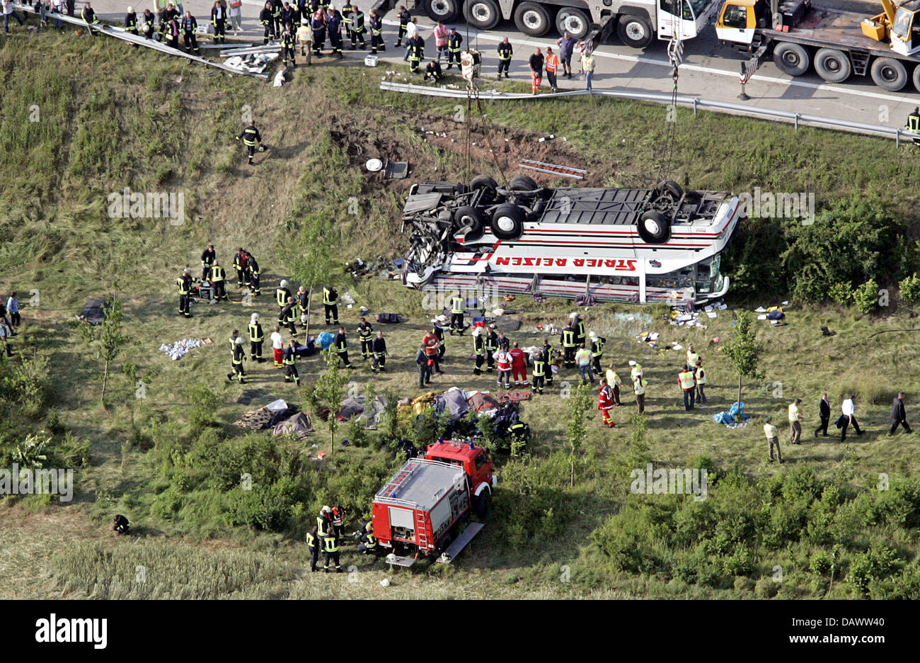 Rescue workers and firemen rescue persons from a crashed coach and ...