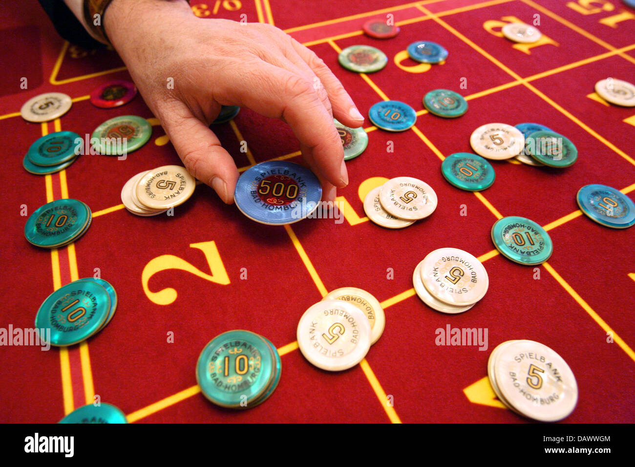 A gambler places his bet at a casino in Bad Homburg, 2 March 2007. On ...