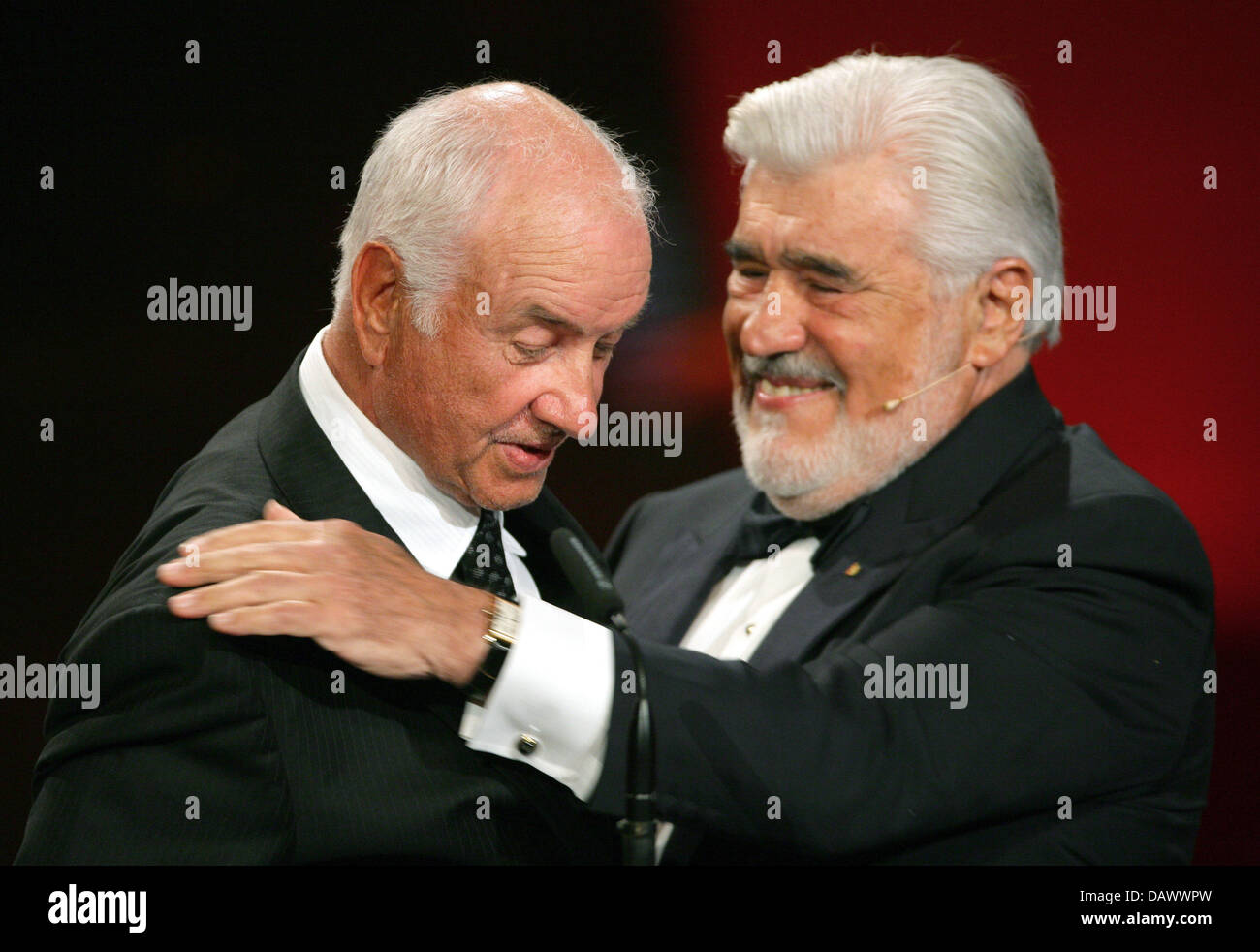 German actor Armin Mueller-Stahl (L) is hugged by laudator Mario Adorf ...