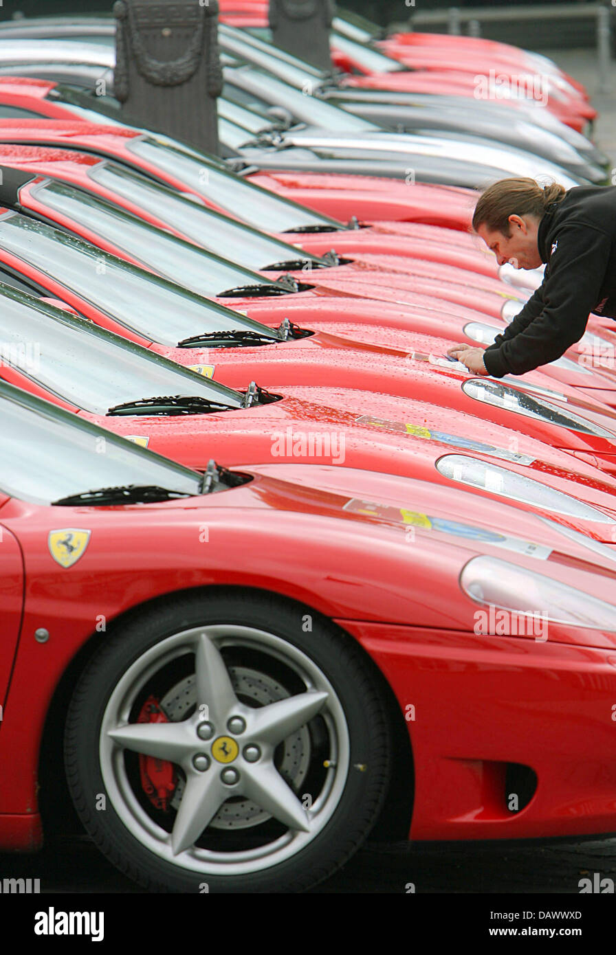 A man puts numbers on Ferrari sports cars in Wiesbaden, Germany 7 May ...