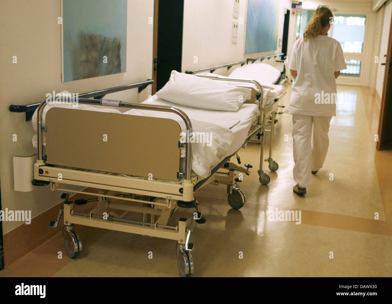 Nurse walks past hospital bed hi-res stock photography and images - Alamy