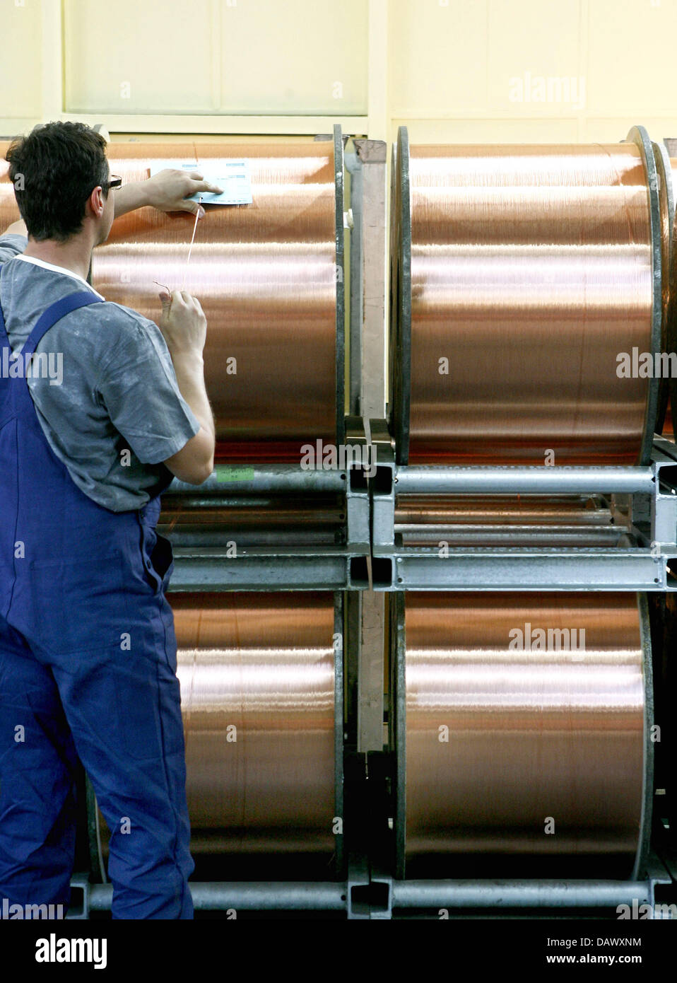 Staff of special cables producer LEONI pictured with copper wire in ...