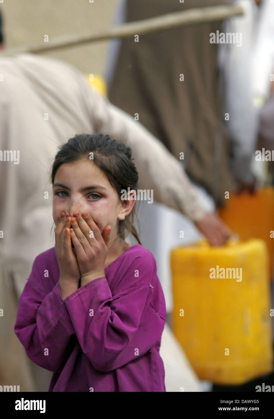 A girl with her hands over her mouth pictured at a public water pipe in ...
