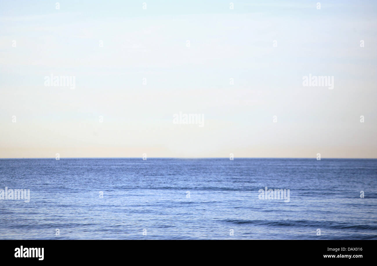 Small waves and a clear blue sky shown near Baltic Sea resort Dierhagen ...