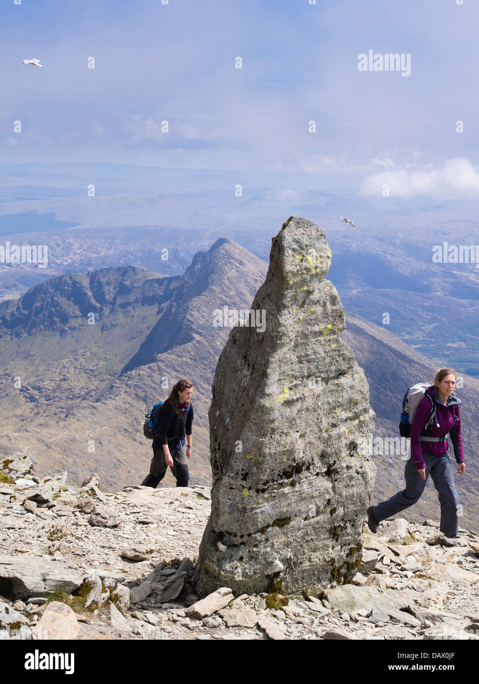 Two women hikers hiking near stone marker at top of Watkin path on ...