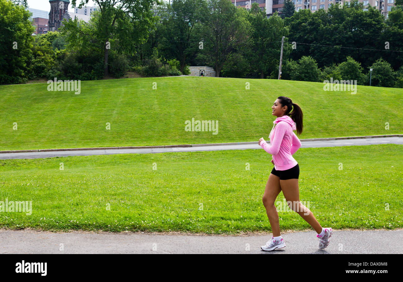 Fit woman running in the city park Stock Photo - Alamy