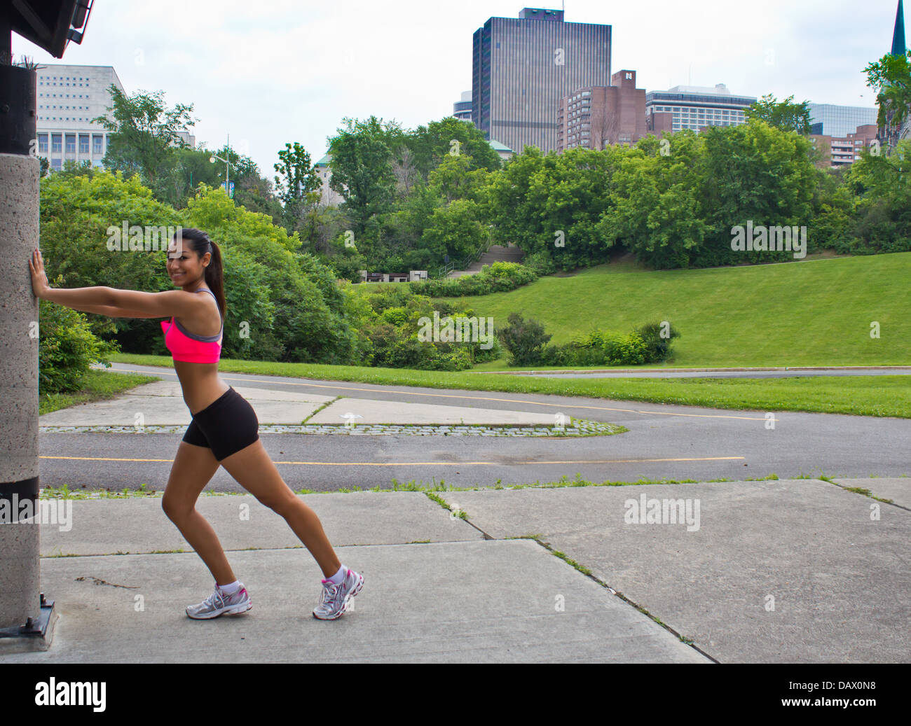 Young woman stretches before running Stock Photo - Alamy