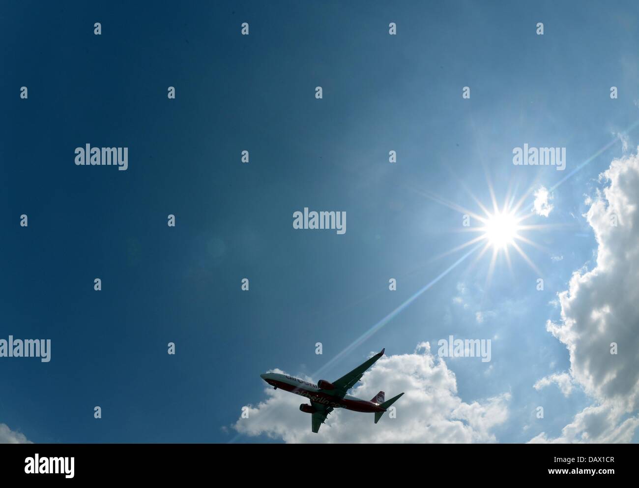 An aircraft lands during sunshine on the airport of Duesseldorf ...