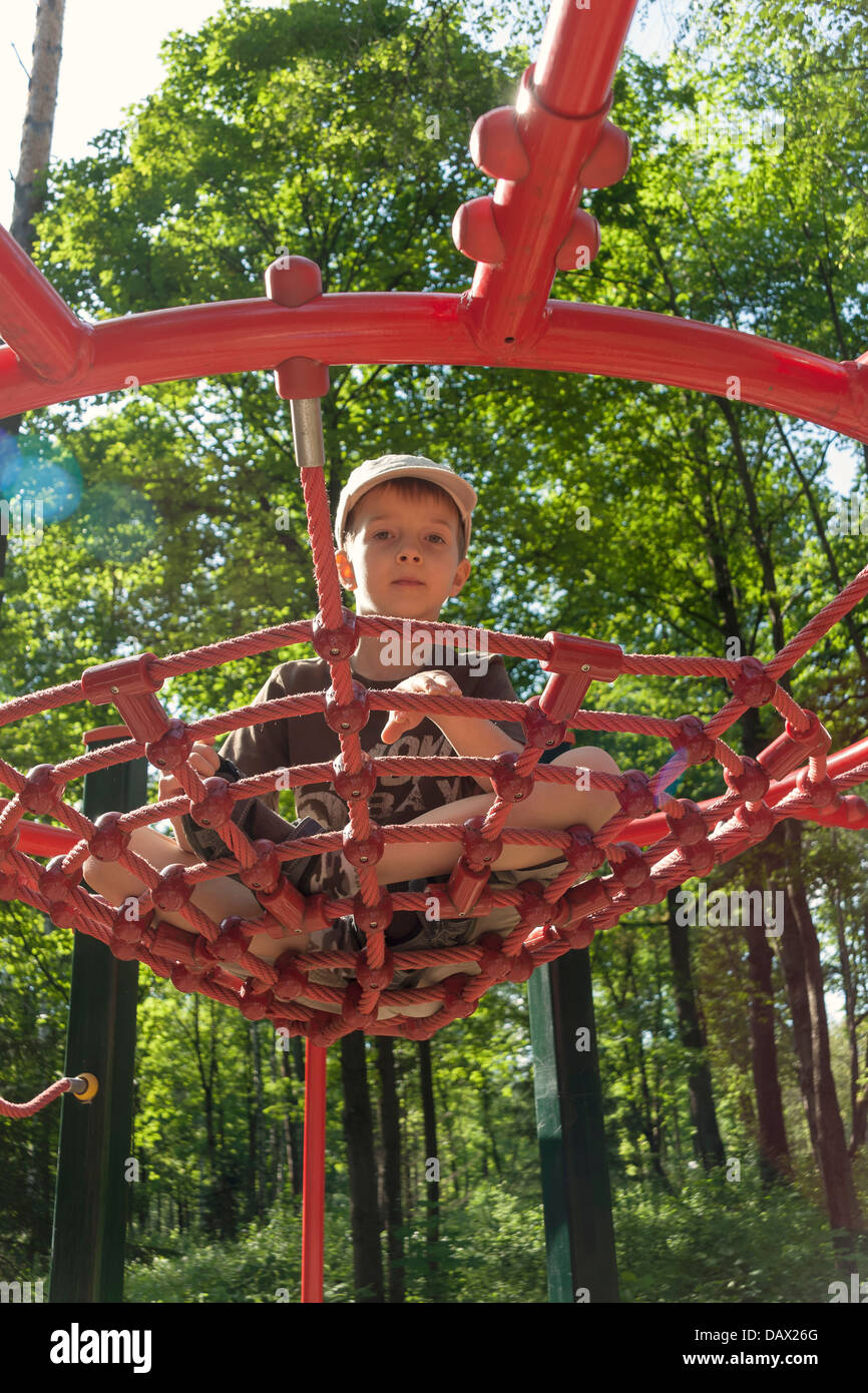 Boy sitting in spider web on playground in Rabka-Zdrój, Poland Stock ...