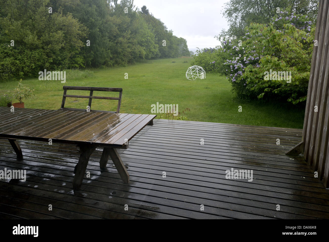 Patio with wooden terrace on a rainy summer day Stock Photo - Alamy