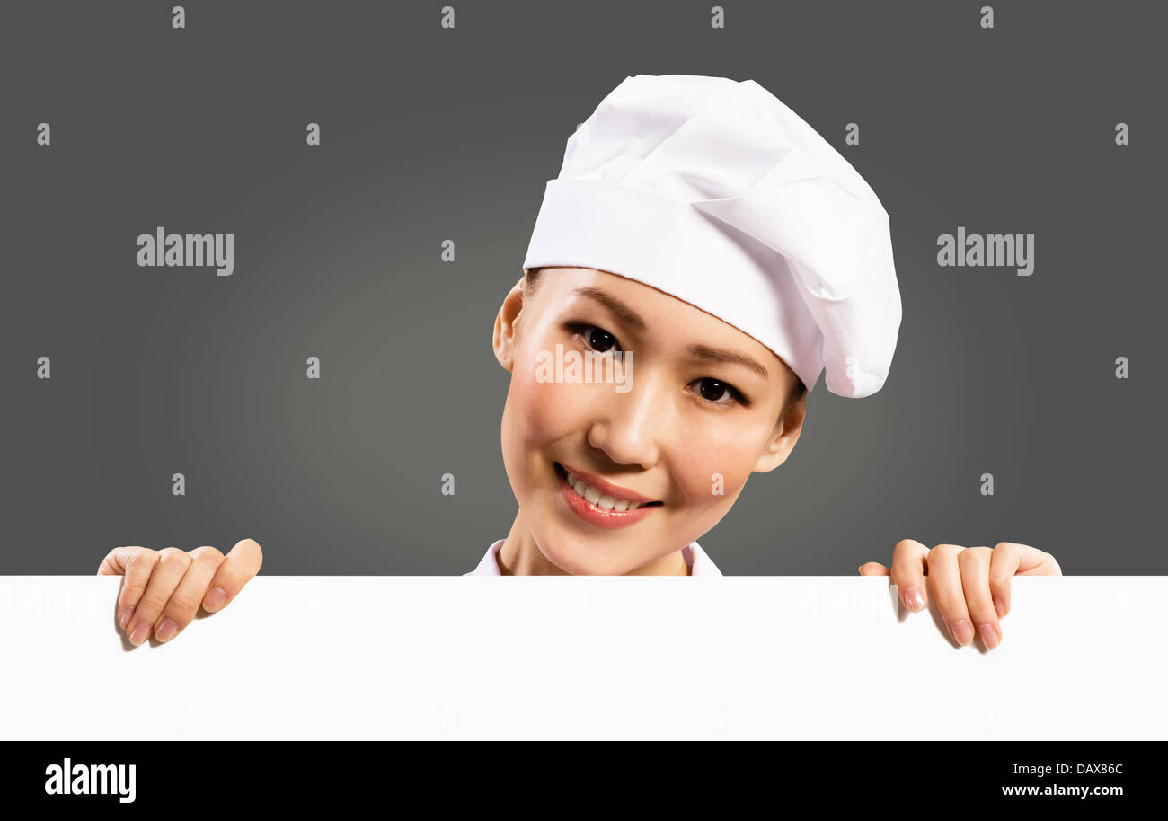 female chef holding a poster for text Stock Photo - Alamy