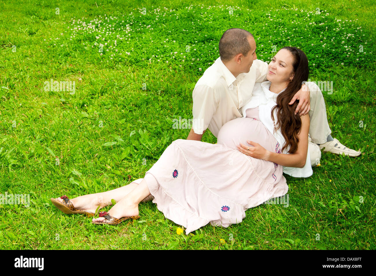 couple lays together, hugging, pregnant woman Stock Photo - Alamy
