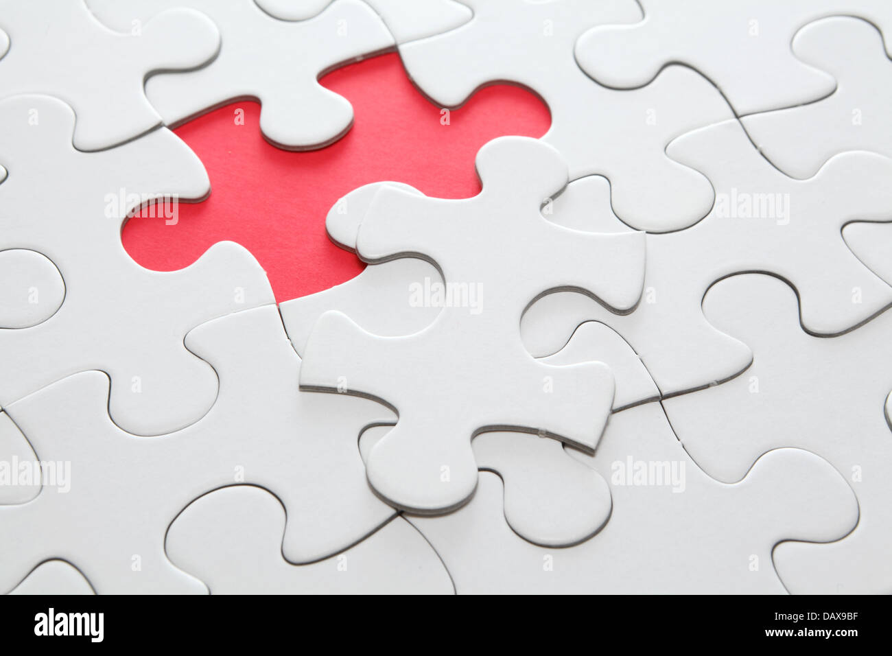 puzzle with missing red piece Stock Photo - Alamy
