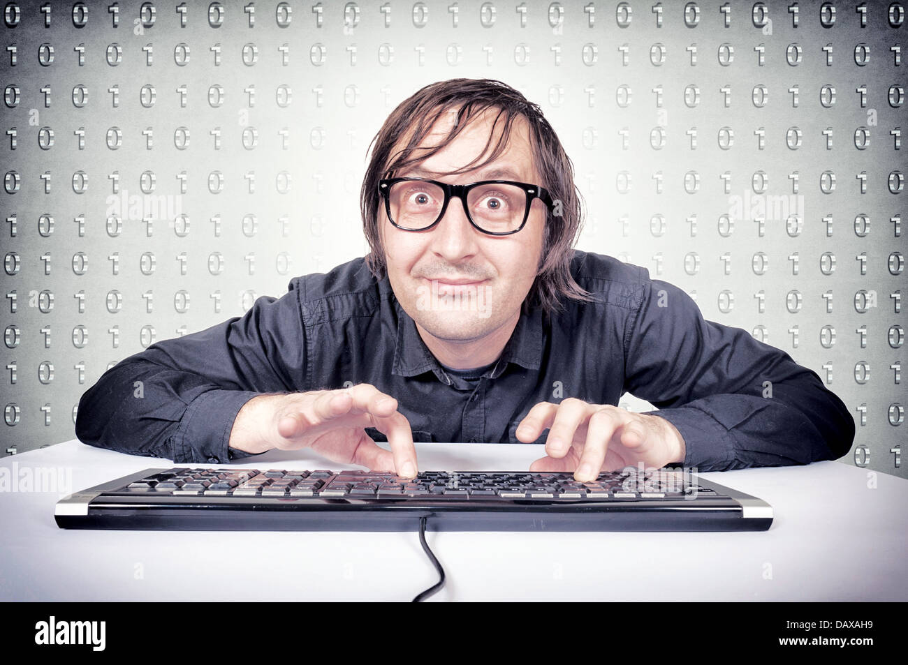 Funny hacker typing on the keyboard Stock Photo - Alamy