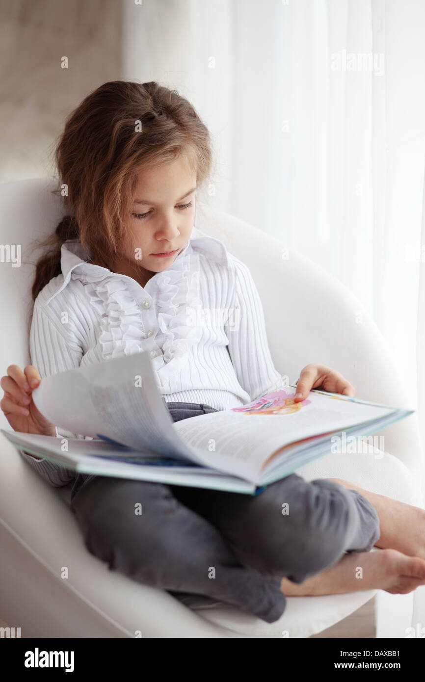 Child reading a book Stock Photo - Alamy