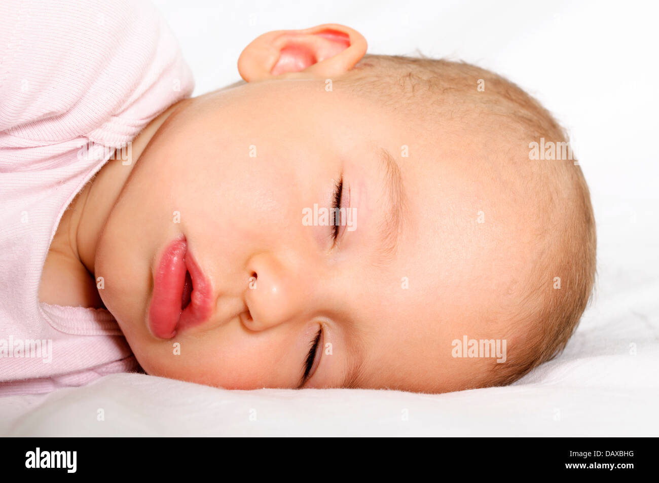 Little baby sleeping on white linen Stock Photo - Alamy