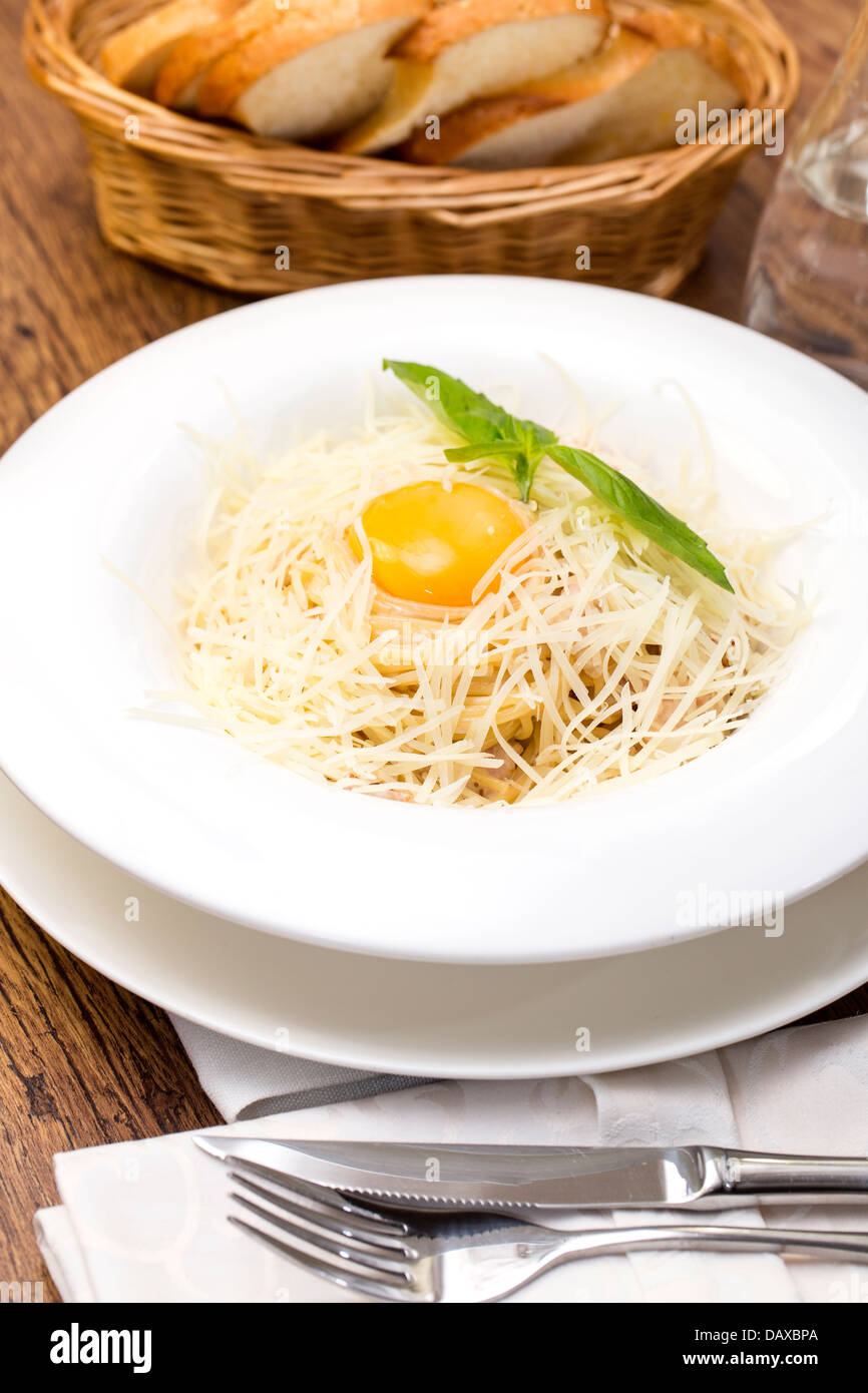 spaghetti with egg on a table in a restaurant Stock Photo - Alamy