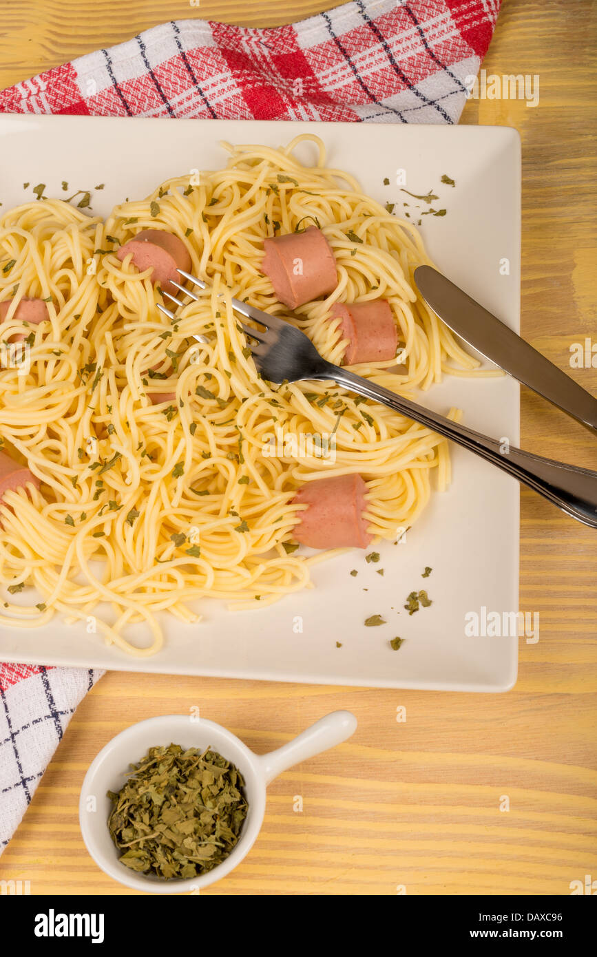 Pasta for kids with spaghetti piercing pieces of sausage Stock Photo ...