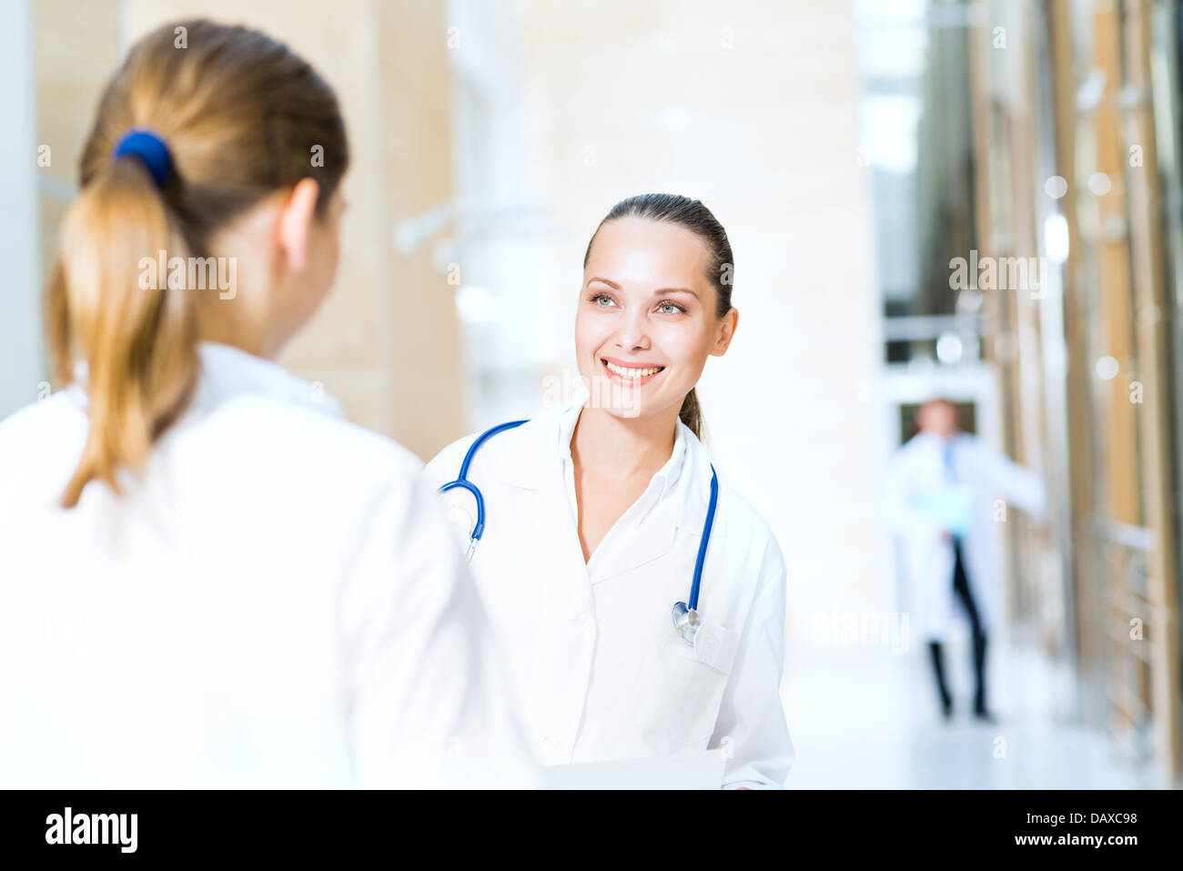two doctors talking in the lobby of the hospital Stock Photo - Alamy