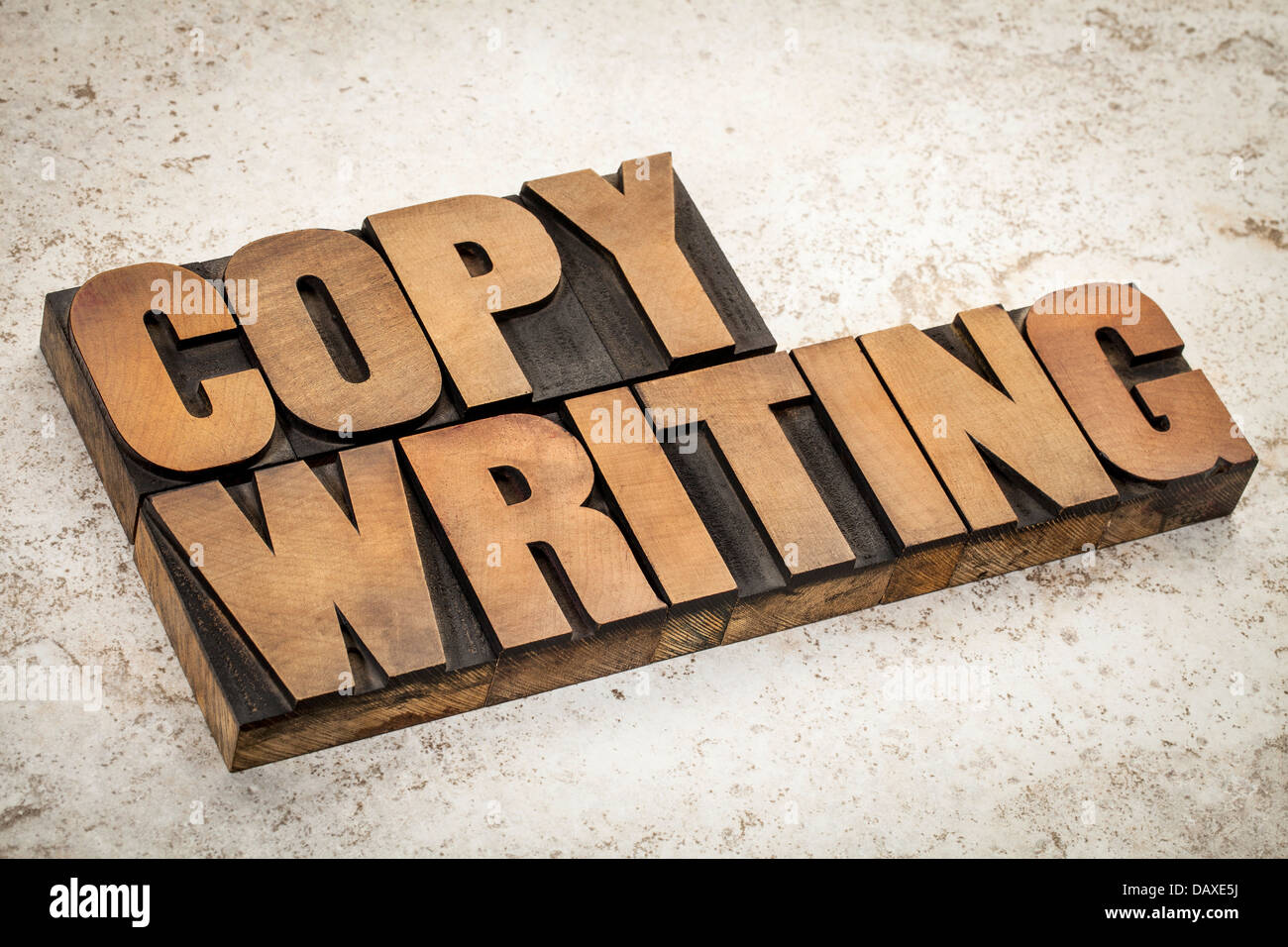 copywriting word in vintage letterpress wood type on a ceramic tile ...