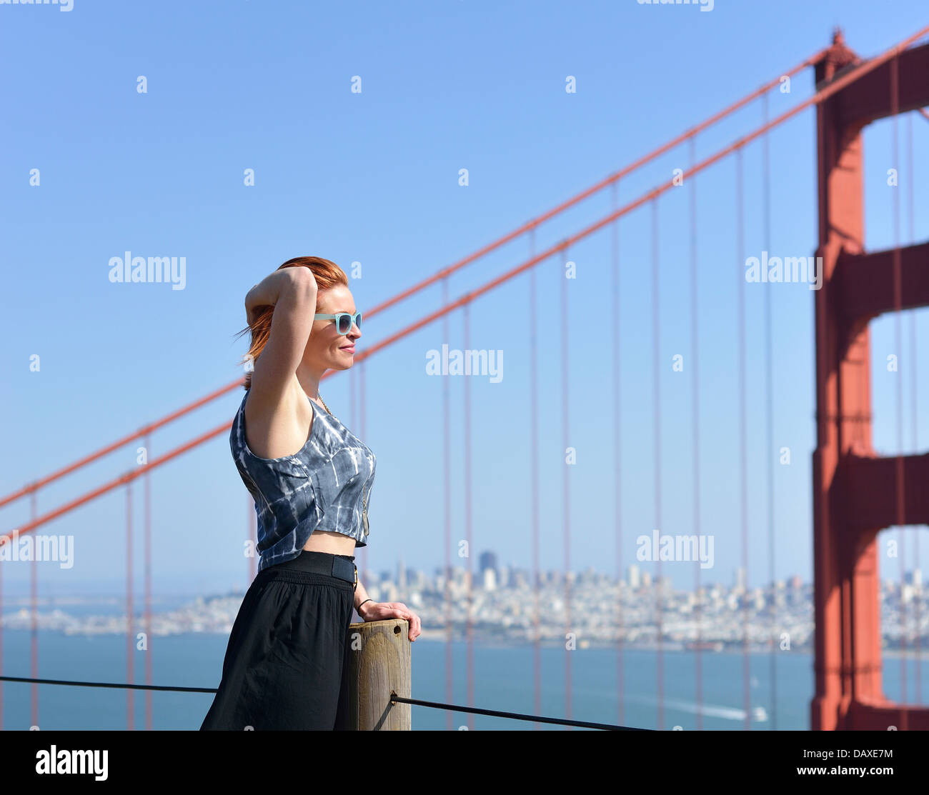 Woman posing with golden gate bridge and San Francisco city background ...