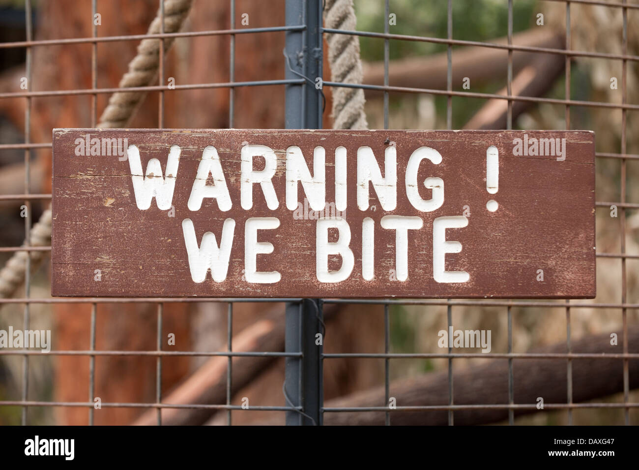 Sign warning that exhibit held within may bite Stock Photo - Alamy