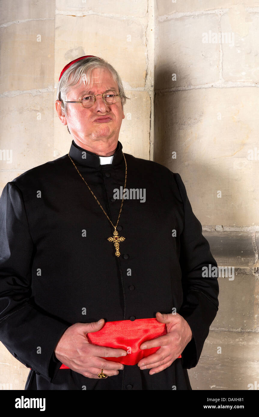 Funny cardinal holding his belly after dinner Stock Photo - Alamy