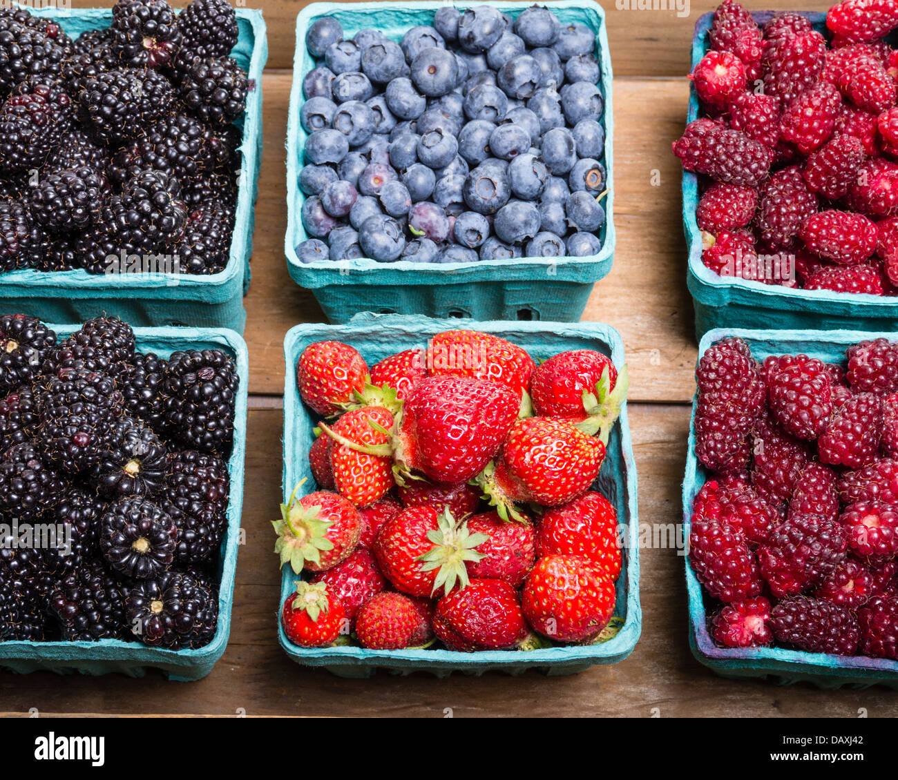 Fresh boxes of assorted berries on display at the farmers market Stock ...