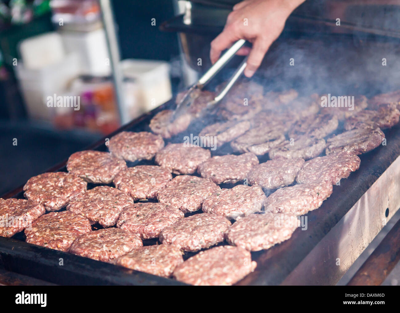 Burgers cooking on a barbecue Stock Photo - Alamy