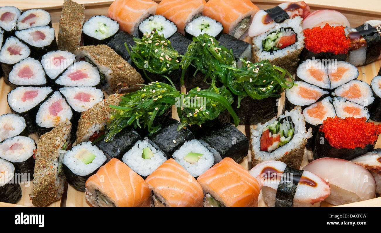 Japanese rolls and sushi in a restaurant with fish and vegetables Stock ...