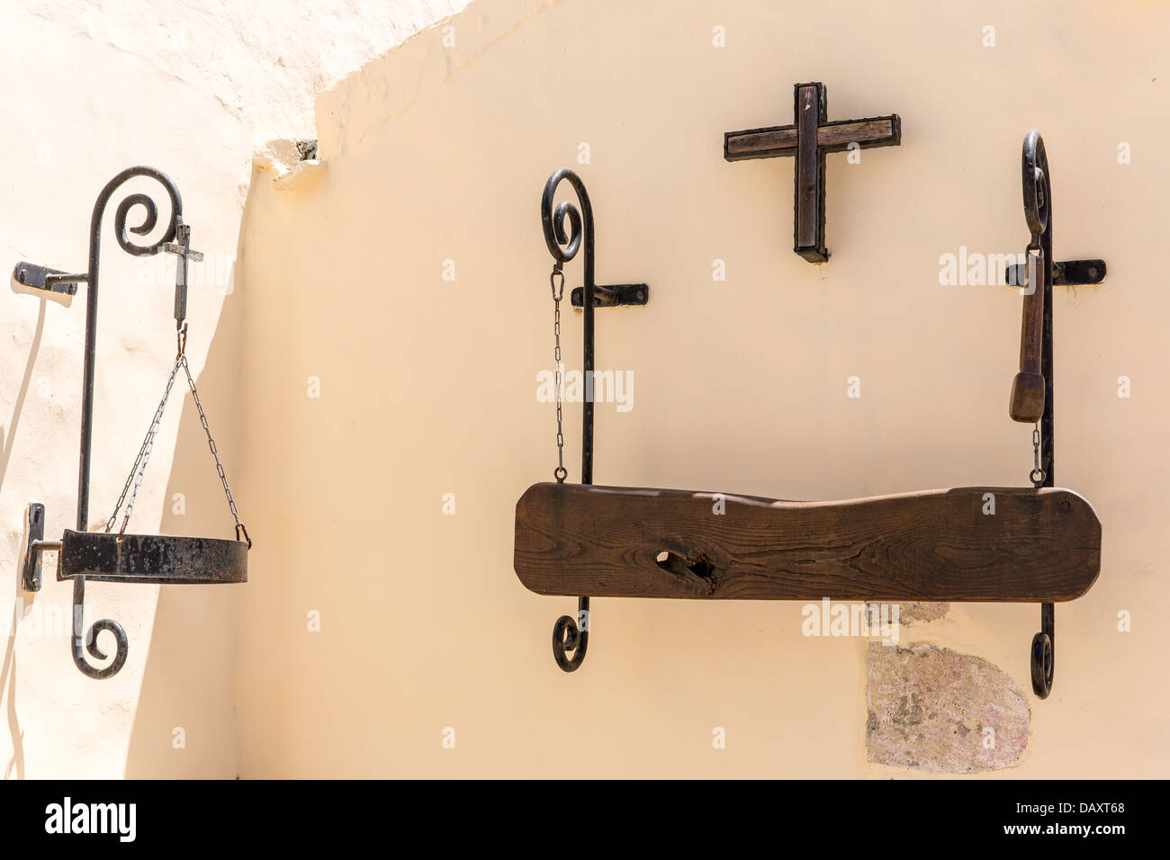 Greek religious symbol,cross,plaque with the name on wall of monastery ...