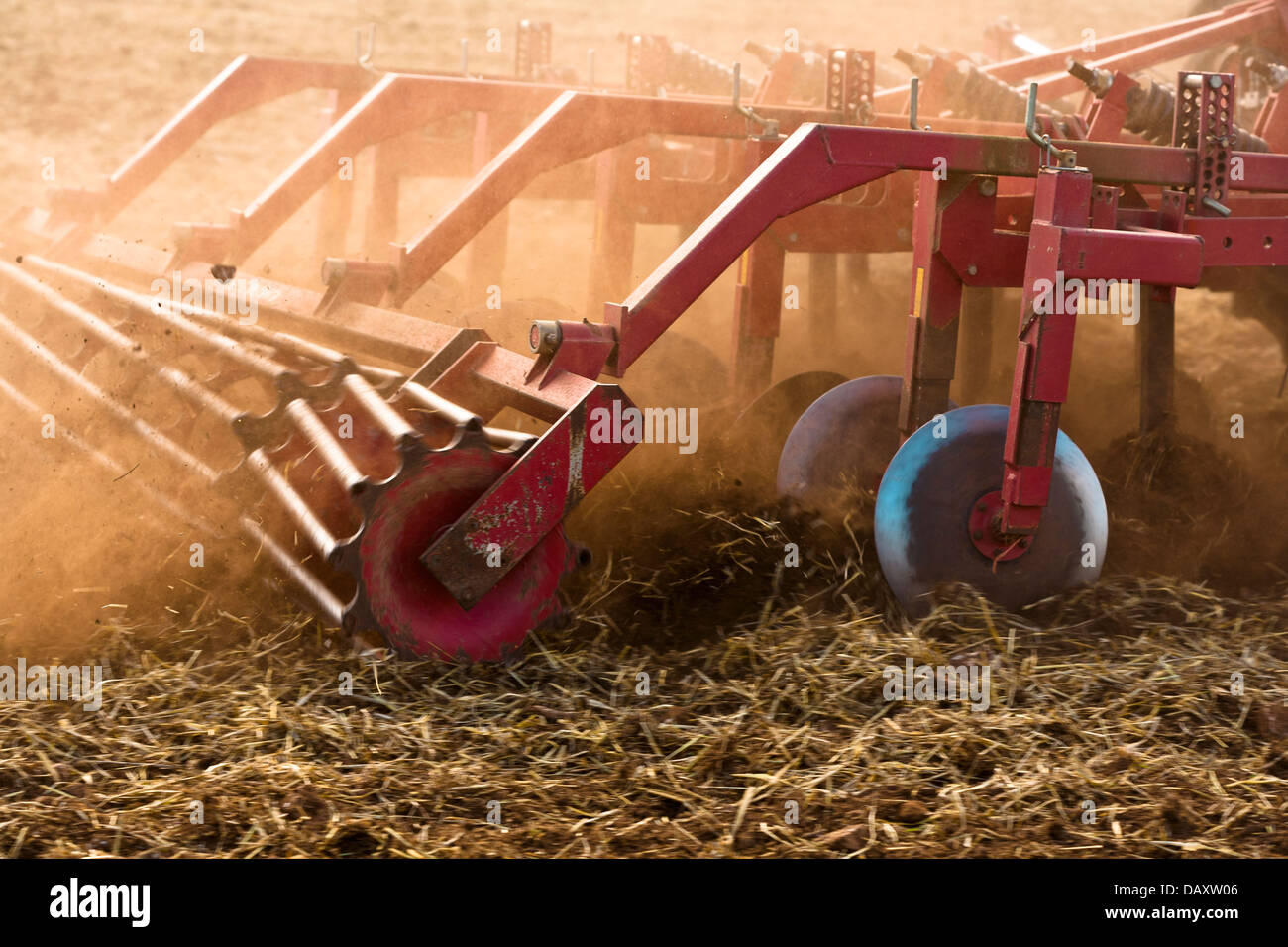 Tractor pulled plough cultivating a field. Motion blur on rotating ...