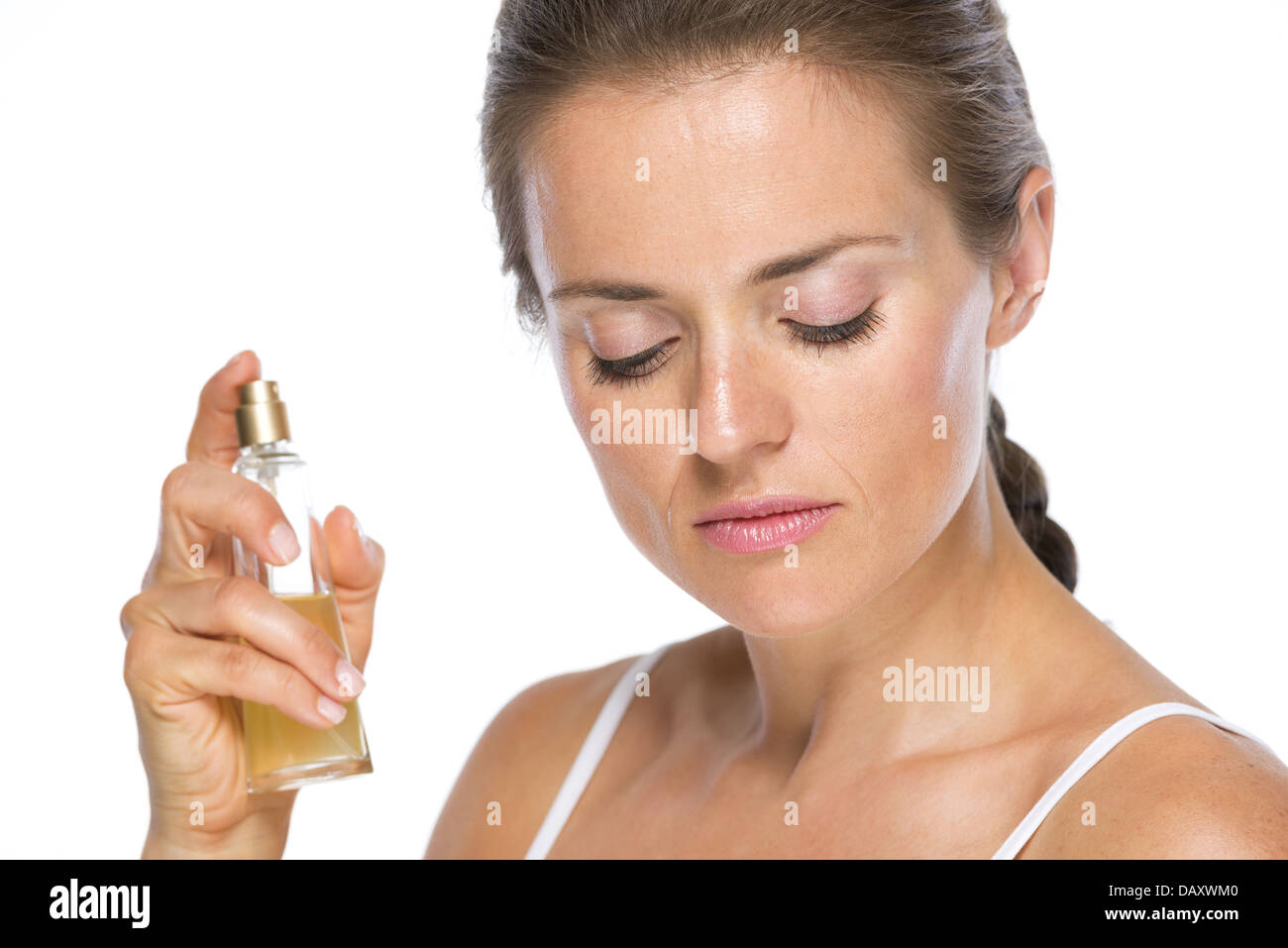 Young woman applying perfume Stock Photo - Alamy