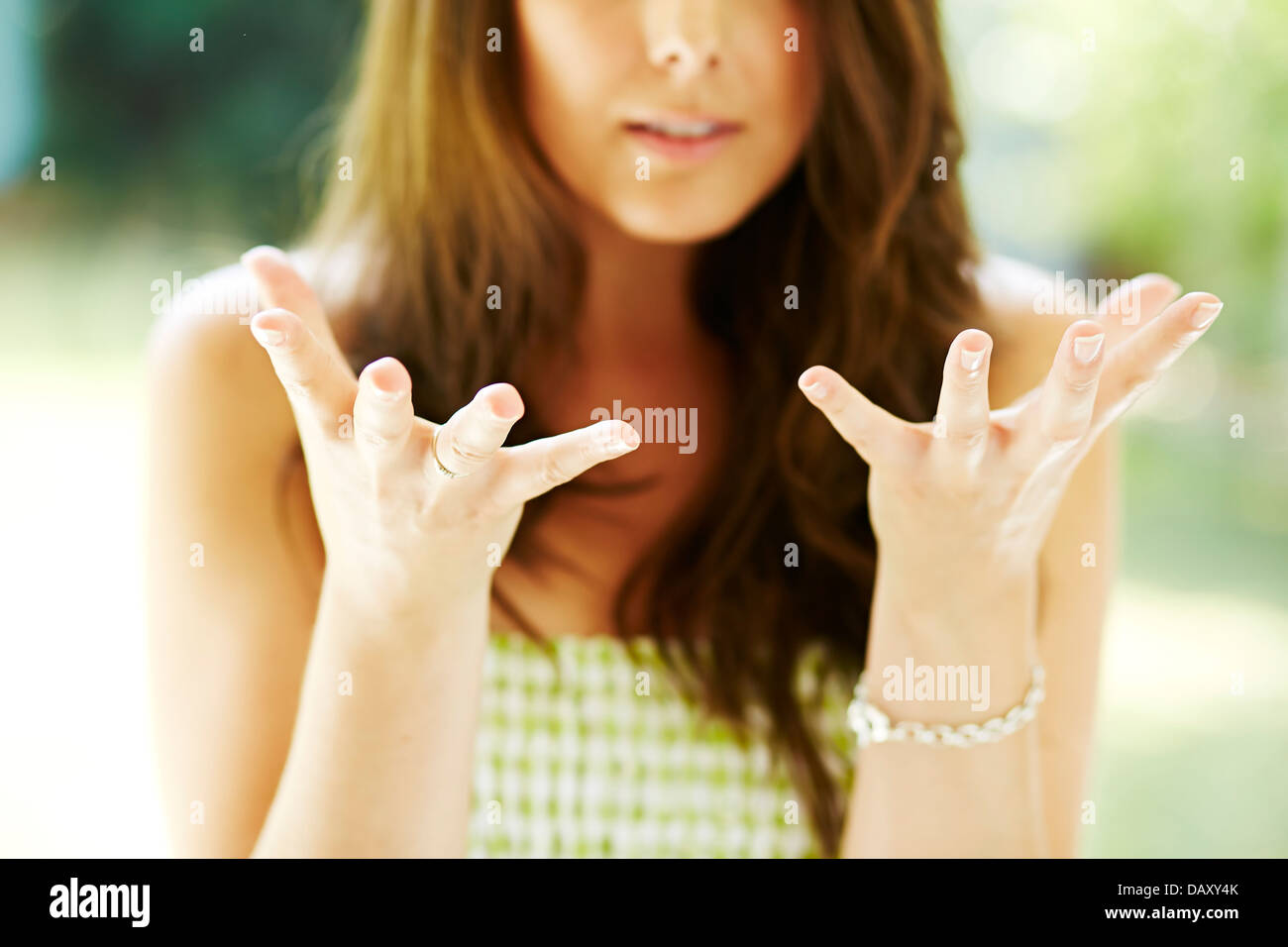 Woman using hands to explain things Stock Photo - Alamy