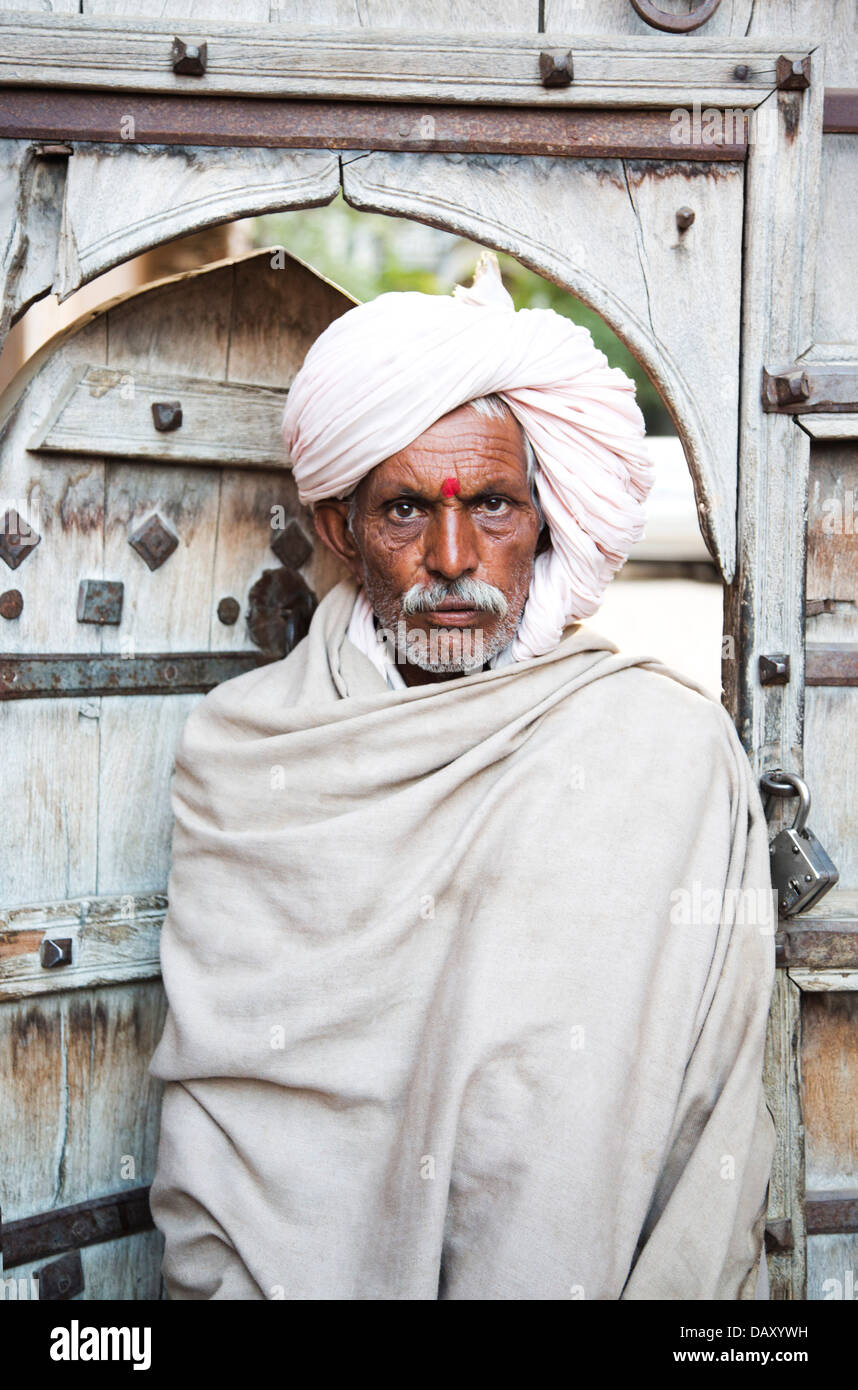 Portrait of a native man standing in front of an old door, Pushkar ...