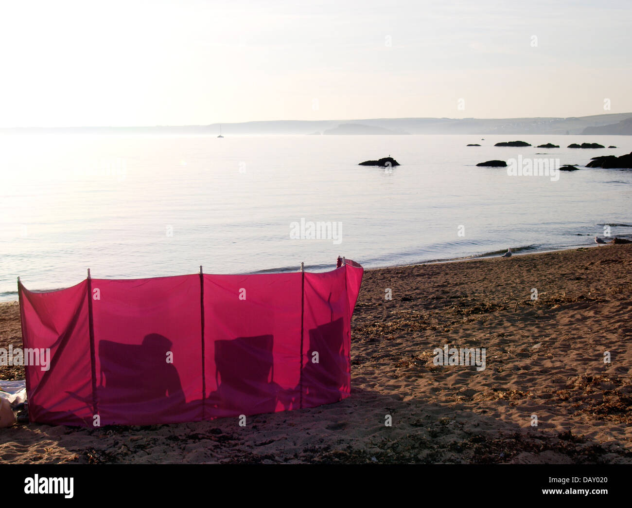People behind windbreak at the seaside hi-res stock photography and ...