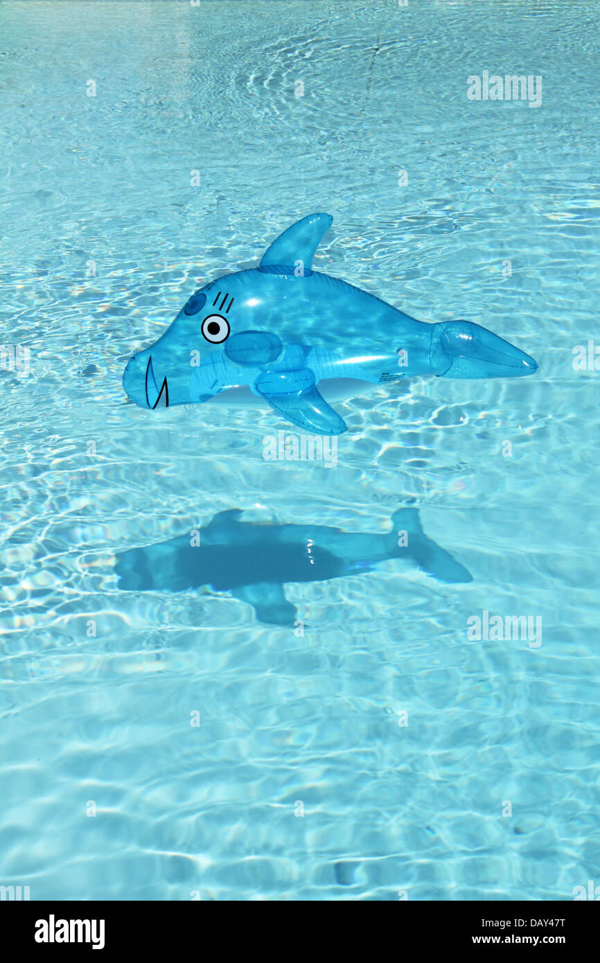 Inflatable dolphin floating in pool Stock Photo - Alamy