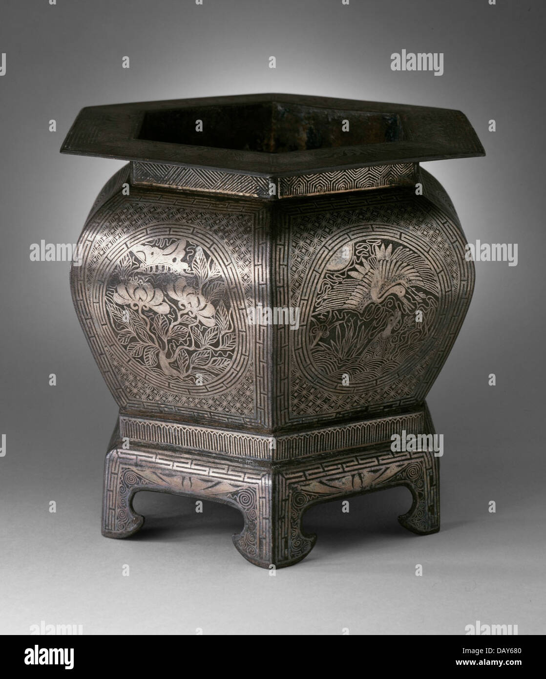 This hexagonal brazier is decorated with roundels featuring flowers and ...