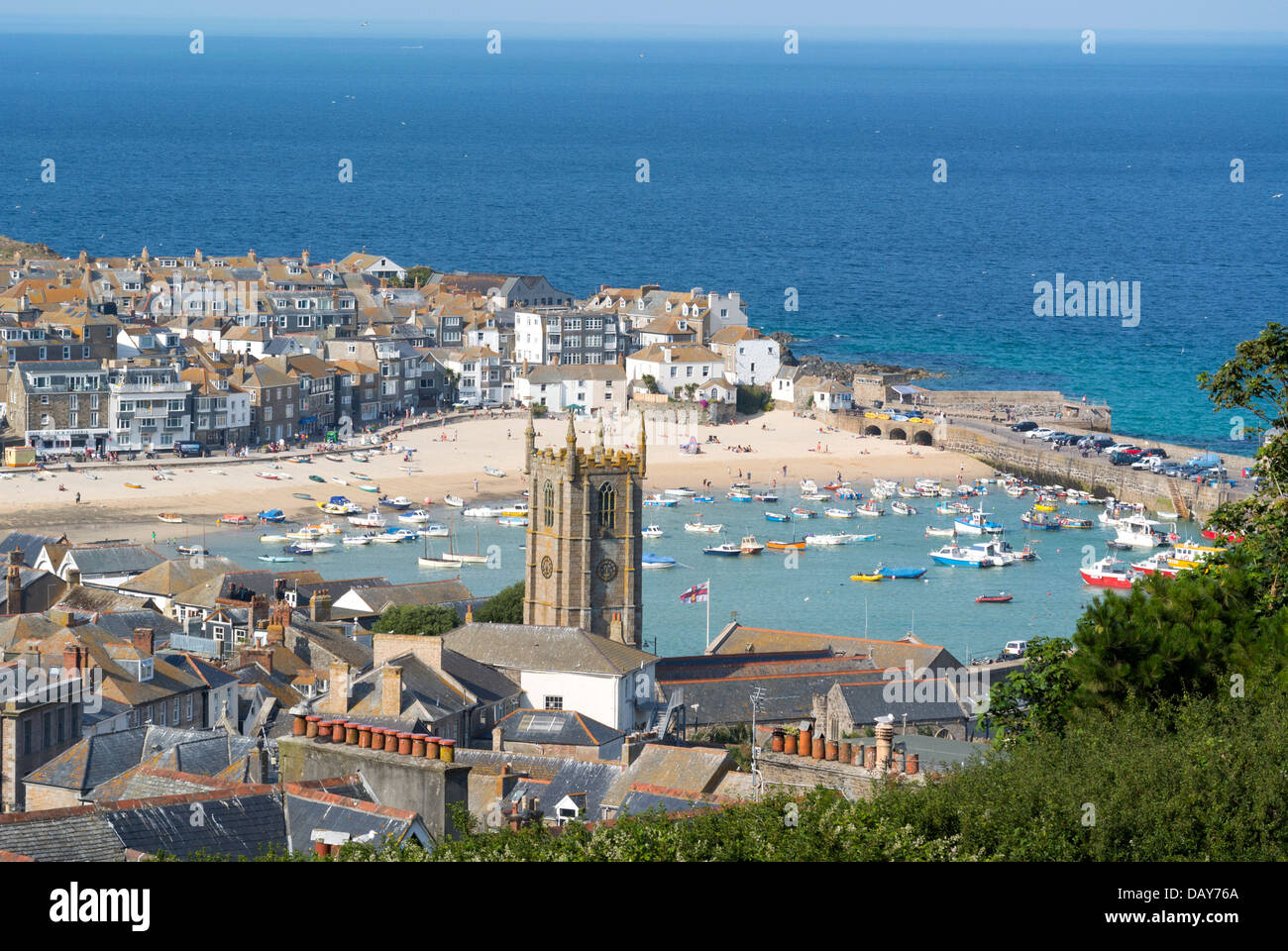 Looking down on St. Ives Cornish seaside town buildings, harbour boats ...