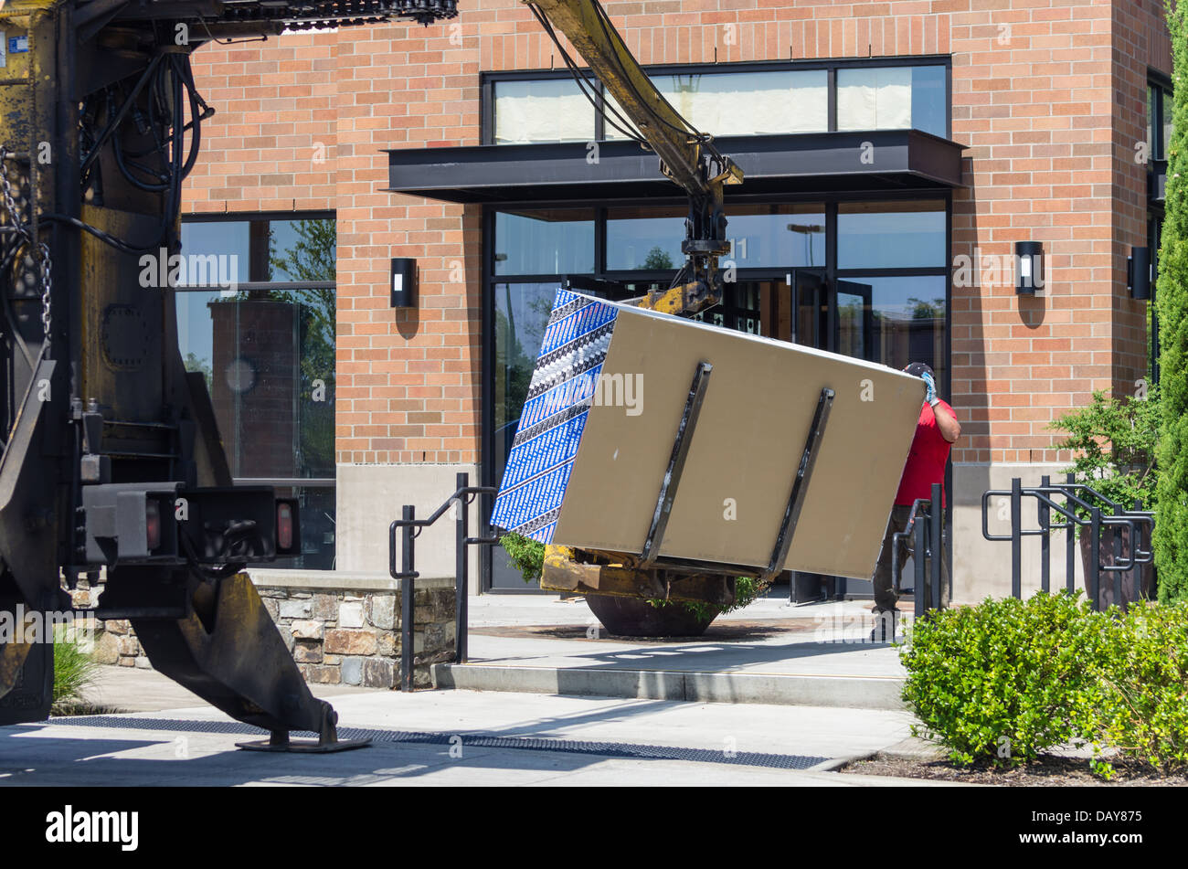 Contractor placing drywall sheets in a building under construction ...