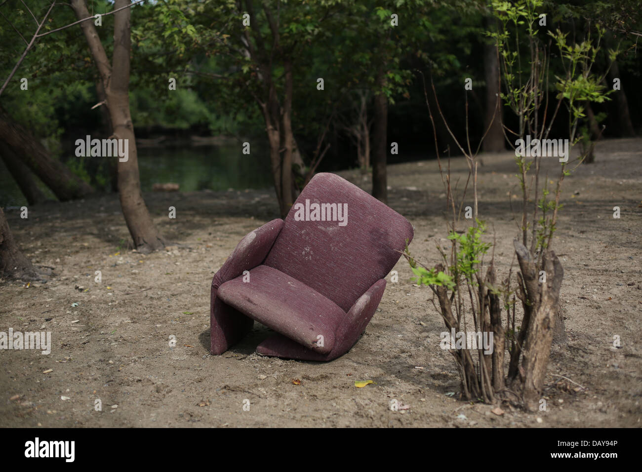 A funny collapsed chair out in the woods Stock Photo - Alamy