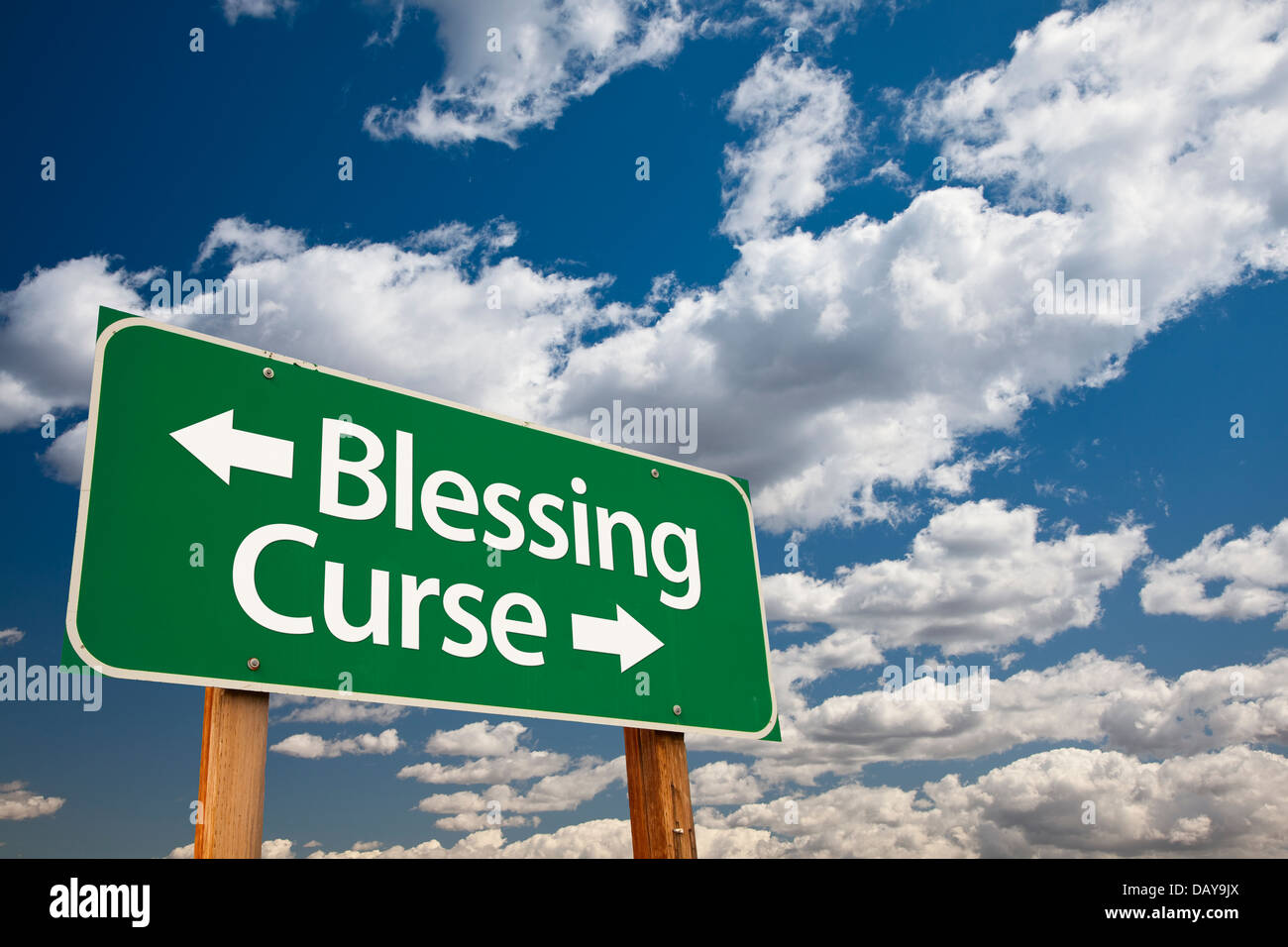 Blessing, Curse Green Road Sign Over Dramatic Blue Sky and Clouds Stock ...